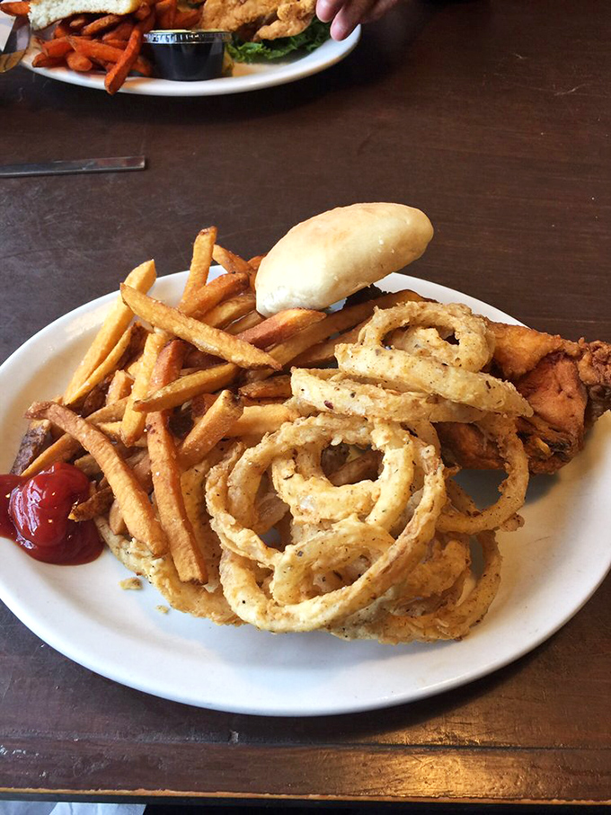 Onion rings so perfectly golden they deserve their own currency. Those aren't just bangles for your plate—they're edible jewelry for your taste buds.
