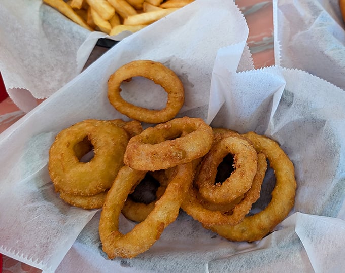 Golden, crispy onion rings that shatter with each bite – the supporting actors that sometimes steal the show from the headlining cheesesteak.