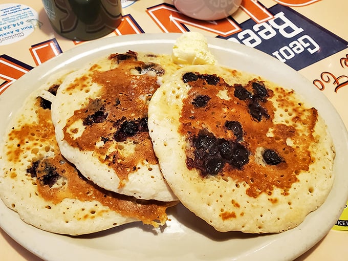 Blueberry pancakes with the perfect char marks—like edible evidence that someone in that kitchen really, really cares about your happiness.