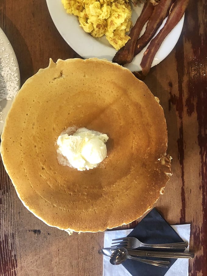 That's not a pancake—that's a golden disc of happiness with a butter crown. The perfect canvas for maple syrup rivers to flow.