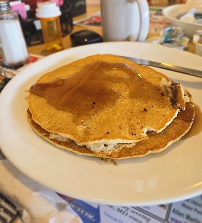 Pancakes that don't need Instagram filters—golden, buttery discs of happiness that make you forget about whatever diet you were considering yesterday.