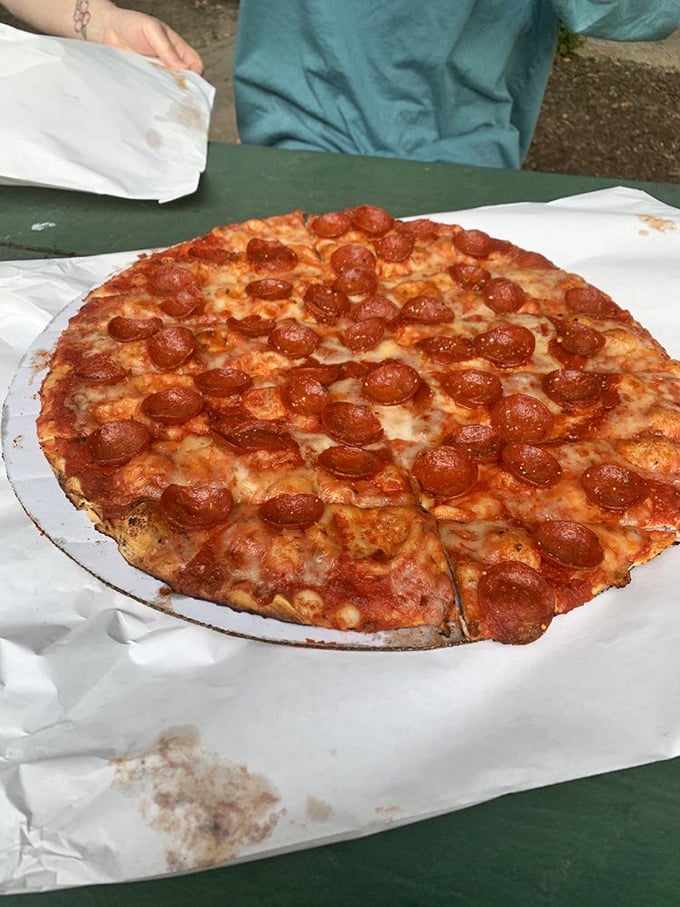 Those pepperoni cups are tiny flavor reservoirs, each one collecting a precious pool of spicy oil. This isn't eating—it's a religious experience.