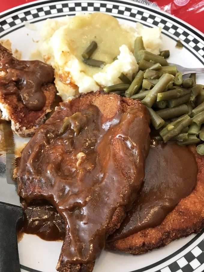 This isn't just country-fried steak – it's a masterclass in comfort food architecture, with gravy cascading over crispy breading like a savory waterfall.