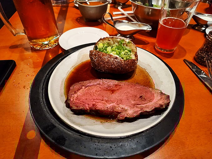 Prime rib so perfectly pink it could make a vegetarian question their life choices. That baked potato isn't just a side—it's a necessary companion for this journey.