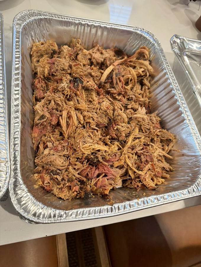 Pulled pork that looks like it's been combed with love—each strand a testament to patience, smoke, and barbecue devotion.