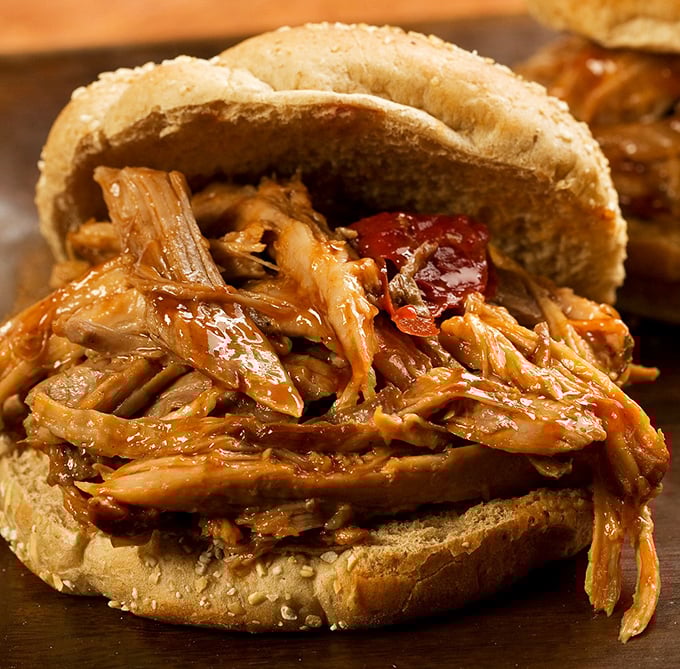 This isn't just a pulled pork sandwich – it's a masterclass in texture and flavor. The kind of sandwich that demands both hands and your full attention.