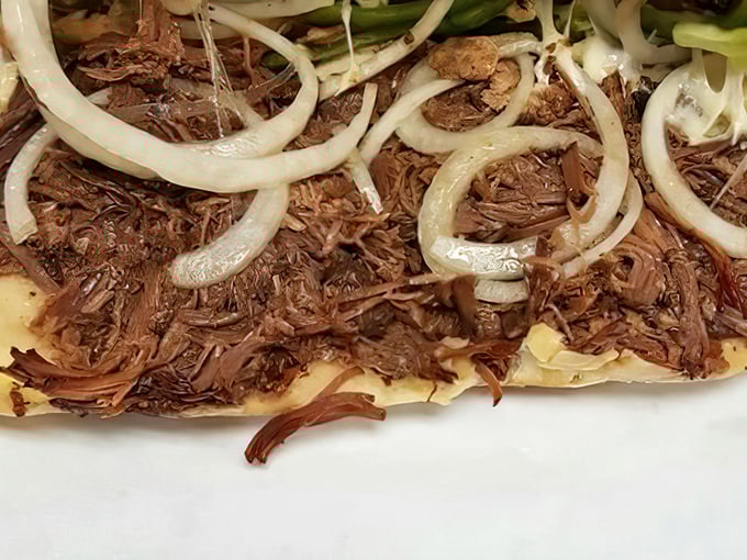 Tender shredded beef topped with sautéed onions—proof that sometimes the simplest combinations create the most profound flavor experiences.