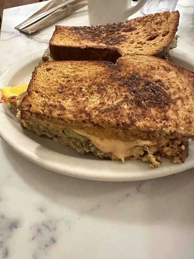 A sandwich that requires both hands and a strategy. That toasted bread cradles its fillings like they're precious cargo—which, let's be honest, they are. 