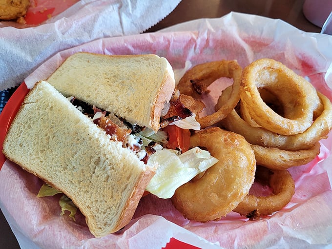A sandwich that requires both hands and several napkins – the hallmark of something truly worth eating. Those onion rings aren't just sidekicks; they're co-stars.