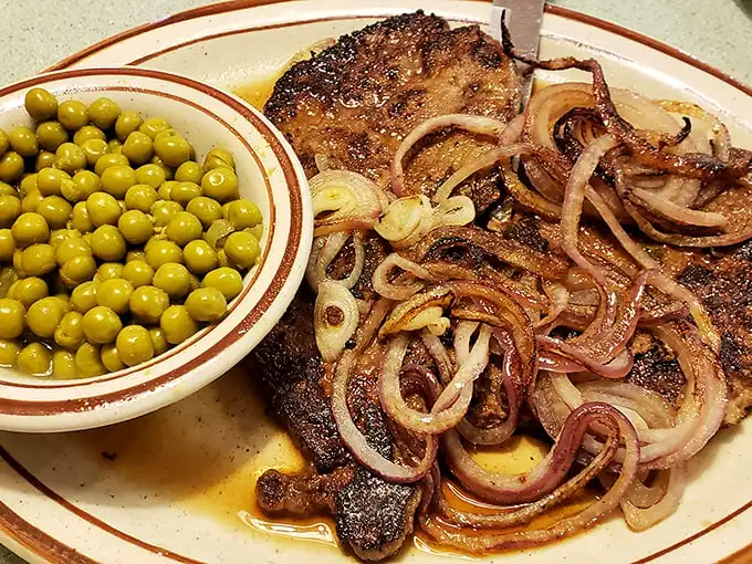 Pork steak swimming in caramelized onions with a side of peas that actually taste like, well, peas. Comfort food that hugs you from the inside out.