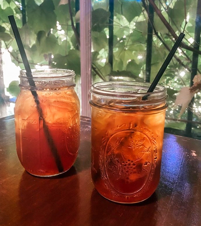 Mason jars of sweet tea—the wine of the South—catching afternoon light through windows, promising refreshment that borders on spiritual experience.