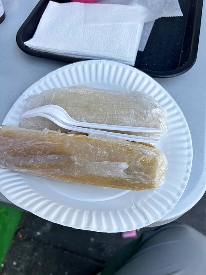 Wrapped like precious gifts, these tamales promise comfort and satisfaction. The simple paper packaging belies the complex flavors waiting inside.