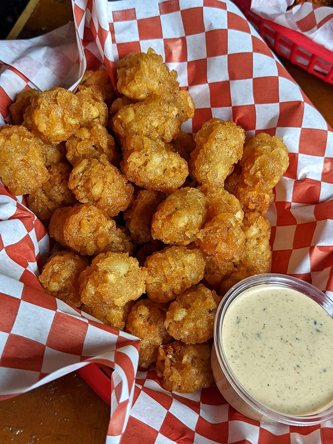 These golden nuggets of fried potato goodness aren't just tater tots – they're little ambassadors of happiness with a dipping sauce diplomatic passport.