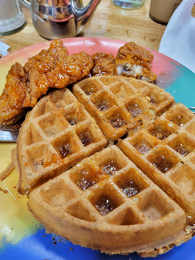 Golden waffles with crispy chicken—the breakfast-lunch alliance that proves some of history's greatest partnerships involve maple syrup. 