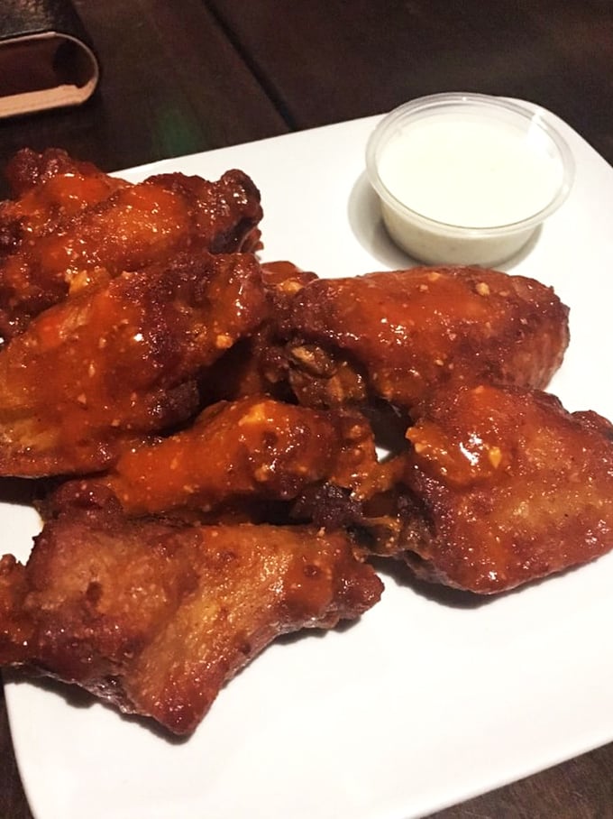 These wings aren't just wings—they're flavor delivery vehicles, glistening with sauce and demanding your full attention. 