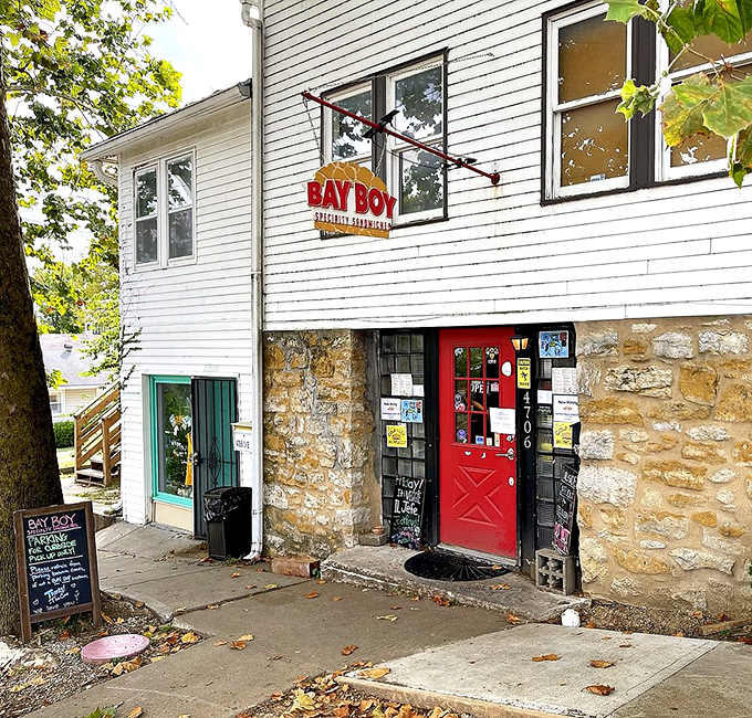 The charming white building with its inviting red door makes Bay Boy look like a storybook cottage that happens to serve incredible sandwiches.