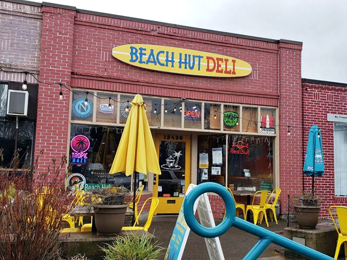 Beach Hut Deli's surfboard sign brings coastal vibes to Tigard—no sand in your sandwich, just pure flavor waves.