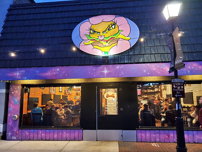 Burger Antics' cosmic purple facade and cartoon mascot promise a flavor adventure beyond ordinary burger boundaries.