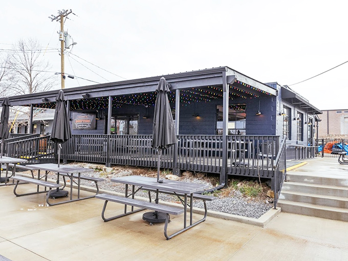 "String lights, picnic tables, and that deep blue exterior—BBQ paradise awaits on warm Tennessee evenings."