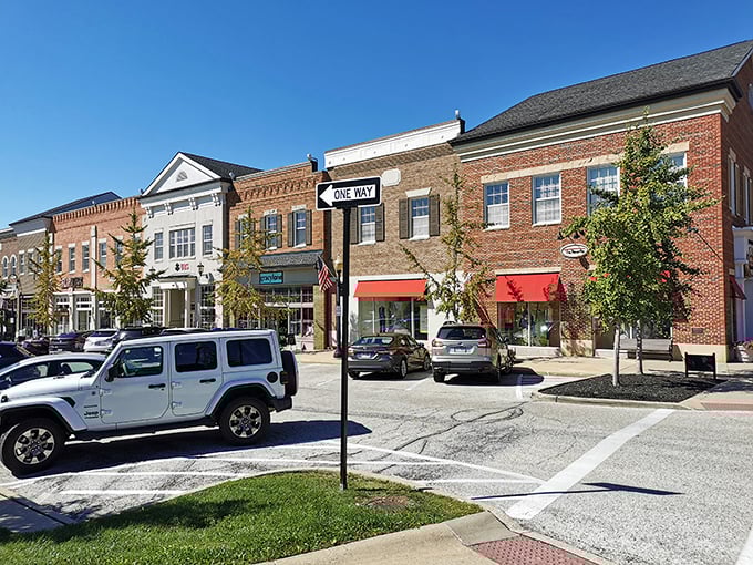 Small-town storefronts line the street, offering an inviting mix of shops where modern charm meets community spirit. Even the sidewalks encourage a leisurely pace.