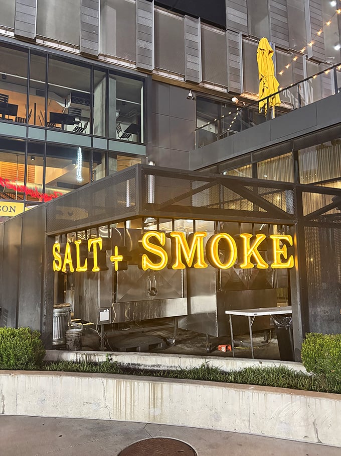 Salt + Smoke's modern exterior and glowing signage hint at the culinary magic happening inside this BBQ-meets-seafood haven.