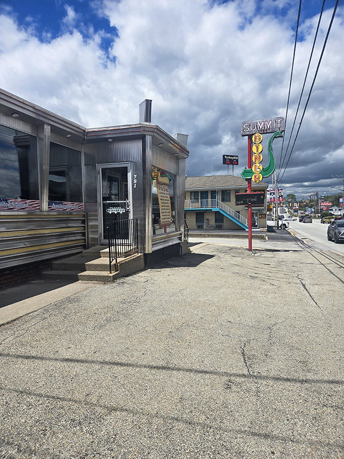 The Summit Diner's classic silver exterior gleams like a chrome time machine. That vintage neon sign has been guiding hungry travelers for generations.