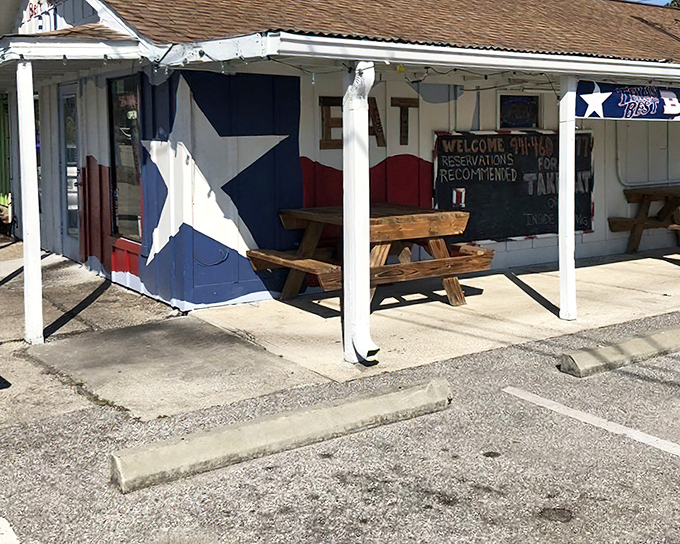 Texas Best Barbecue wears its Lone Star pride on its sleeve – and its walls. The Texas flag mural promises authentic smoked meat inside.