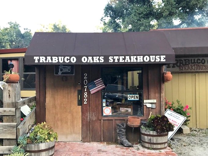 Trabuco Oaks' cabin-in-the-woods vibe sets the perfect rustic tone. That American flag and wooden exterior promise an authentic steakhouse experience without pretension.