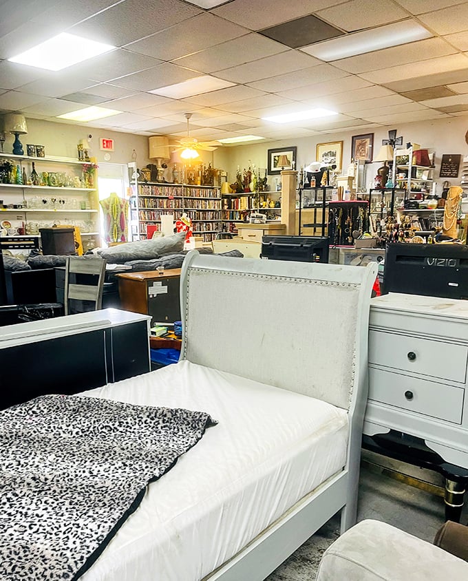 Inside AZ Thrift, furniture treasures await – that white bed frame might be someone's perfect guest room solution!