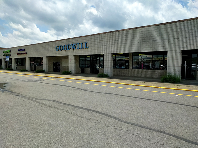 The sprawling Goodwill storefront stretches across the shopping plaza, promising room after room of secondhand surprises.