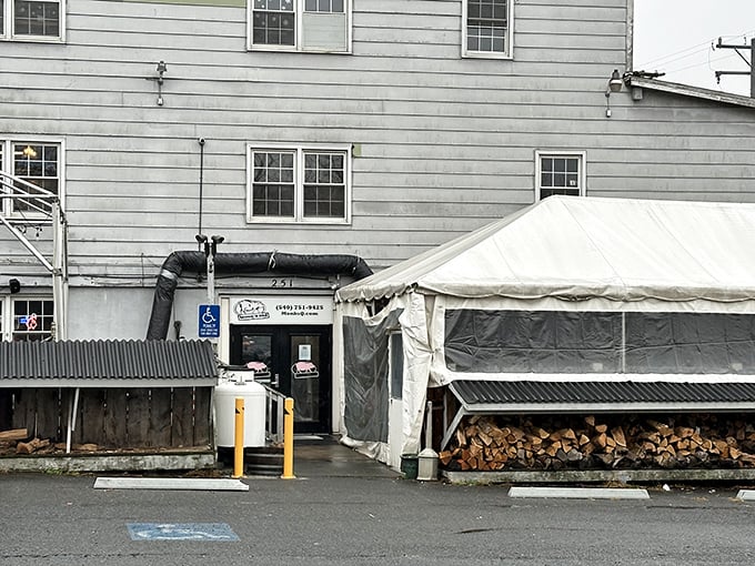 Monk's understated entrance hides a world of smoke and flavor. That tent means business is good—very good.