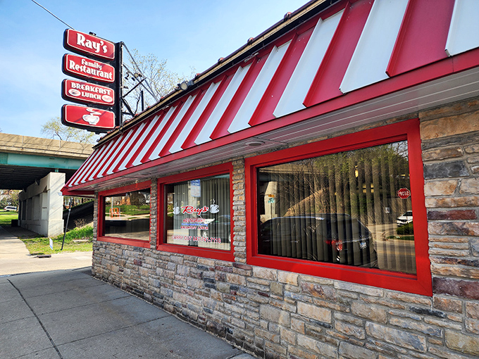 Ray's sign promises "Breakfast Specials" beneath that unmistakable red and white striped awning. Where morning meals come with a side of small-town warmth.