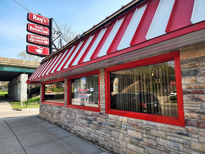 Ray's sign promises "Breakfast Specials" beneath that unmistakable red and white striped awning. Where morning meals come with a side of small-town warmth.