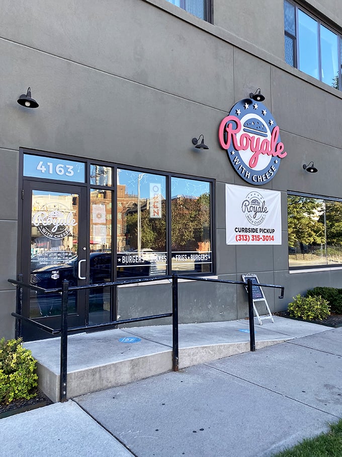 Even in daylight, Royale with Cheese maintains its cool factor. That neon sign isn't just clever—it's a promise of movie-worthy burger experiences.