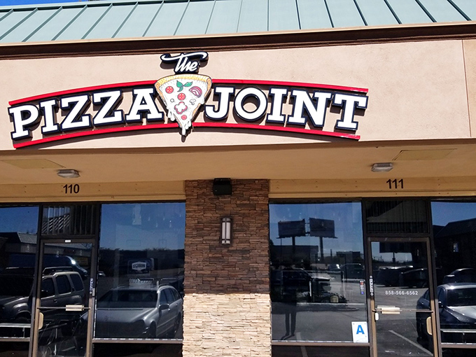 No pretension, just pizza perfection – The Pizza Joint's sign tells you everything you need to know about their straight-shooting approach.