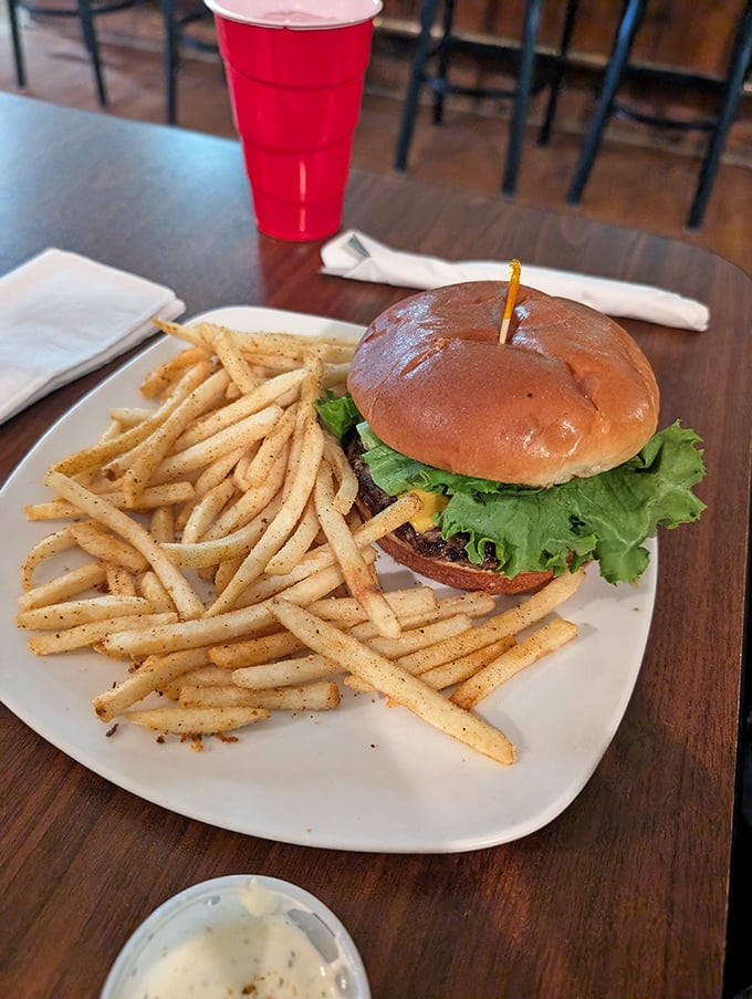 A burger that doesn't need fancy toppings to impress—just quality beef, melted cheese, fresh lettuce, and a mountain of seasoned fries.
