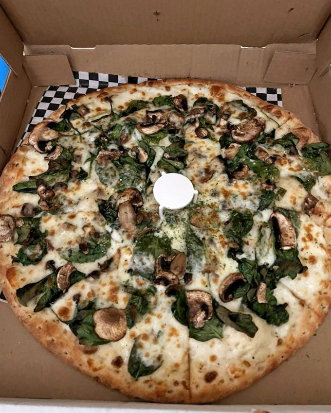 A vegetarian's dream pizza. Earthy mushrooms and vibrant spinach prove that meatless doesn't mean flavorless in this cheesy masterpiece.