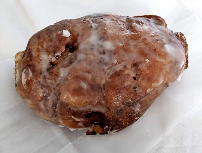 Not all heroes wear capes—some, like this apple fritter, wear a glaze that glistens like morning dew on autumn leaves.