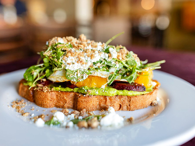 Avocado toast elevated to an art form—this isn't just breakfast, it's edible architecture with a foundation of freshness and a roof of microgreens.