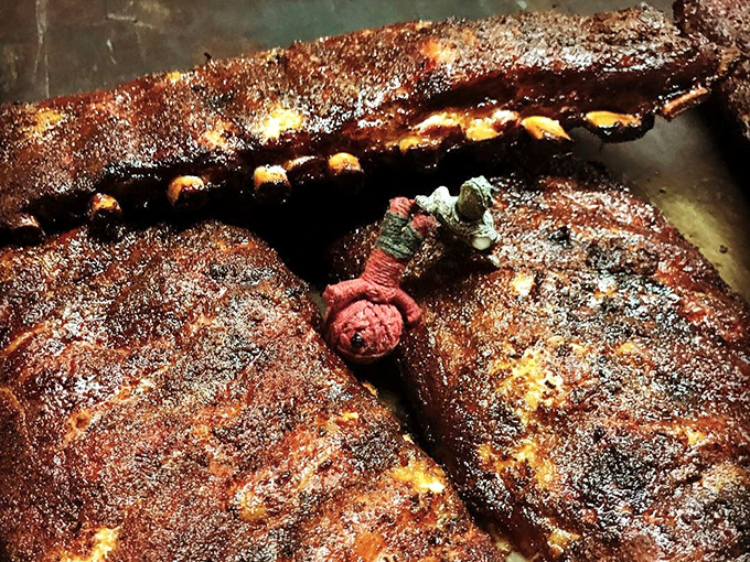 These ribs wear their pepper-crusted bark like a tuxedo to the meat prom. The bone peeking through is just showing off.