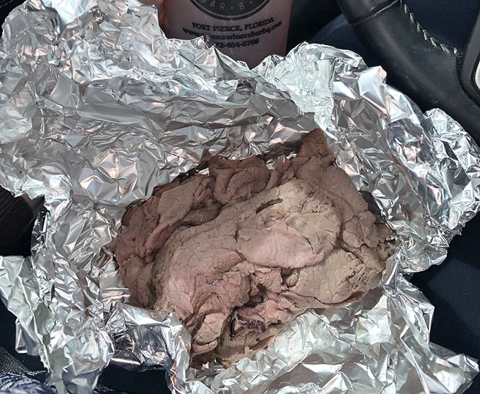 Behold, the holy grail of BBQ beef—tender slices nestled in foil like a meaty treasure. This is what smoke and patience taste like.
