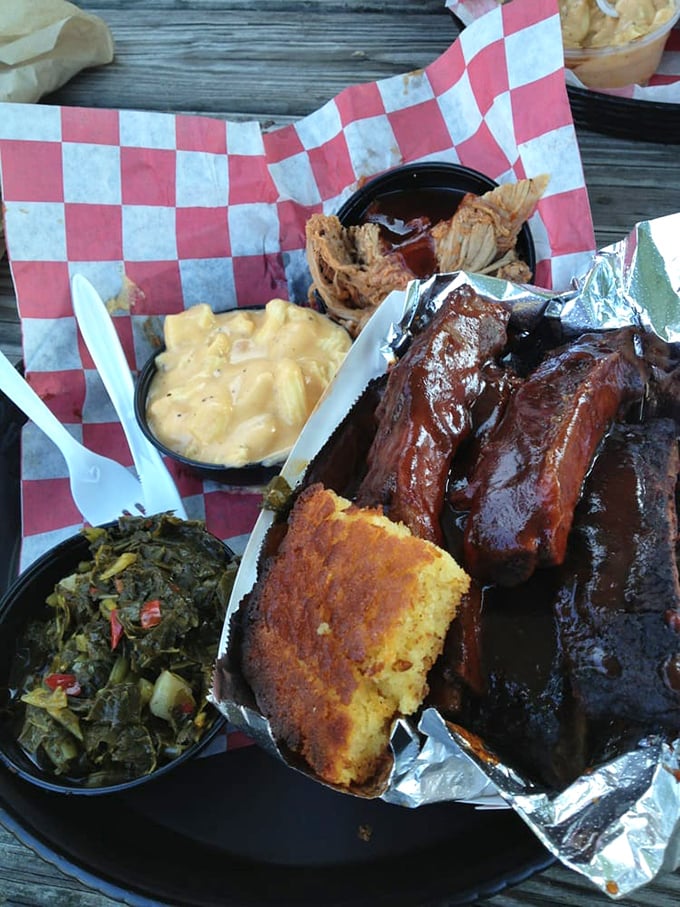 A BBQ platter that belongs in the Louvre—glistening ribs, tender pulled pork, mac and cheese, and collards that would make any Southerner weep with joy.