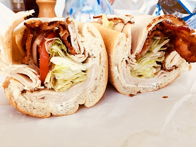 This sandwich isn't just lunch – it's architecture. Perfectly stacked turkey, crisp lettuce, and fresh tomato in cross-section glory.