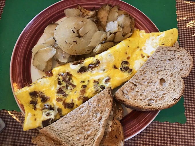 An omelet that knows its purpose in life—to deliver maximum cheese and bacon in every bite, with toast standing by for moral support.
