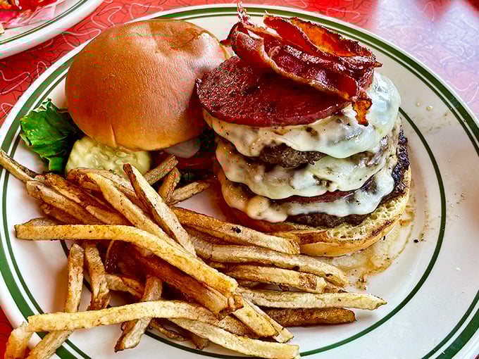 This isn't just a burger—it's a skyscraper of beef, cheese, and bacon that requires both hands, several napkins, and absolutely zero shame.