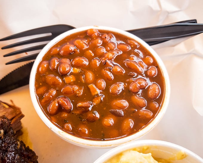 These baked beans aren't just a side dish—they're a supporting actor that deserves its own Oscar, rich with molasses and studded with bits of smoky meat.
