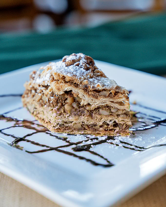 This baklava slice sits pretty on its plate, flaunting layers that would make a wedding cake weep with envy.