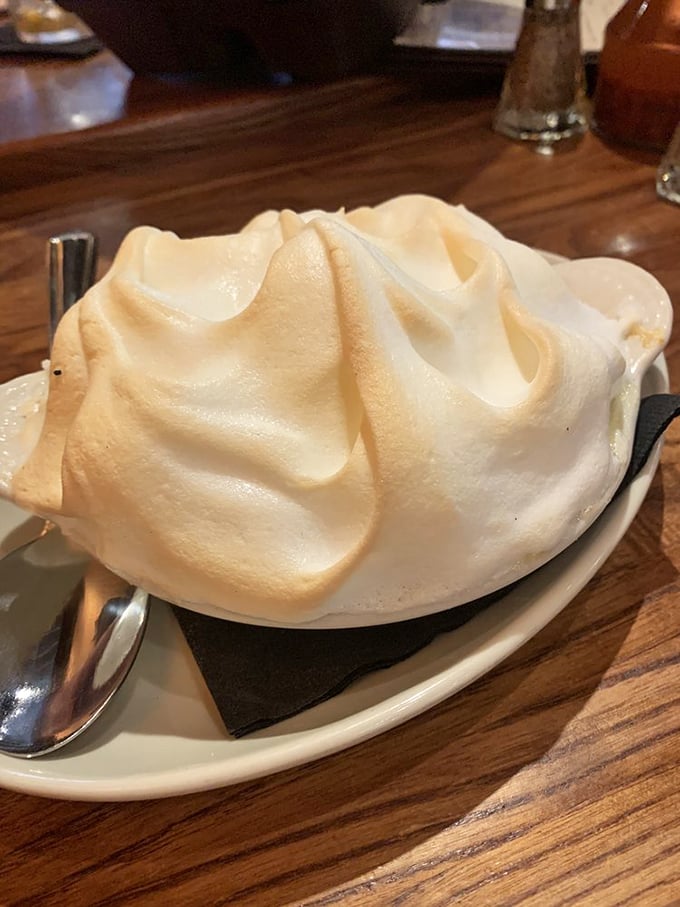 Banana pudding crowned with a cloud of meringue that's toasted to golden perfection—proof that angels work in The Pit's kitchen.