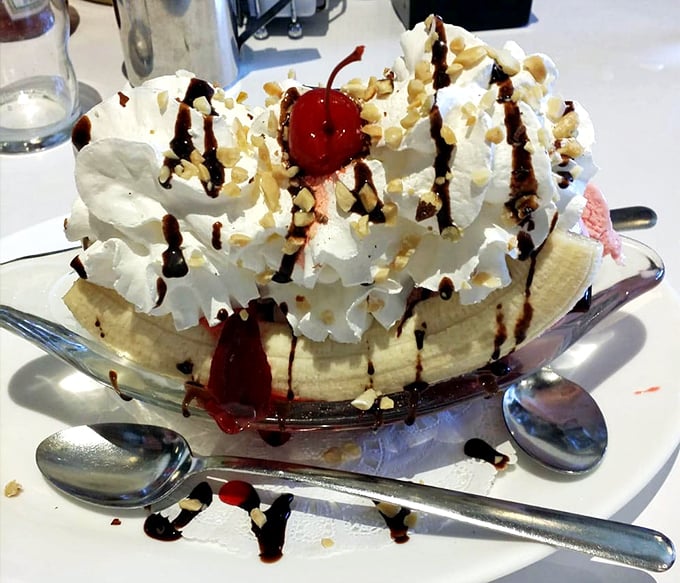This banana split isn't just dessert—it's architecture, sculpture, and pure joy, all in a boat-shaped dish that's begging to be shared but too good to actually share.
