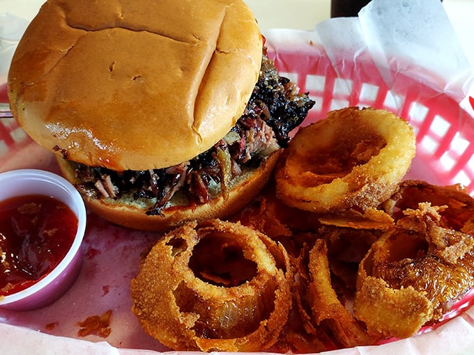 This brisket sandwich doesn't need fancy presentation—it's too busy being the reason stretchy pants were invented. Those onion rings aren't shy either.